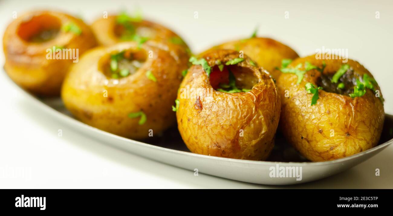Mini jacket potatoes with a fragrant garlic butter infused with Italian ...