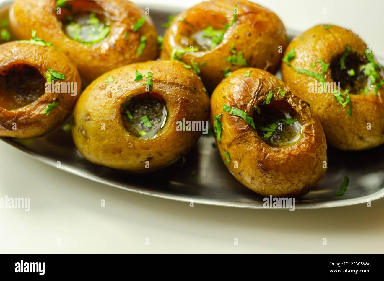 Mini jacket potatoes with a fragrant garlic butter infused with Italian ...