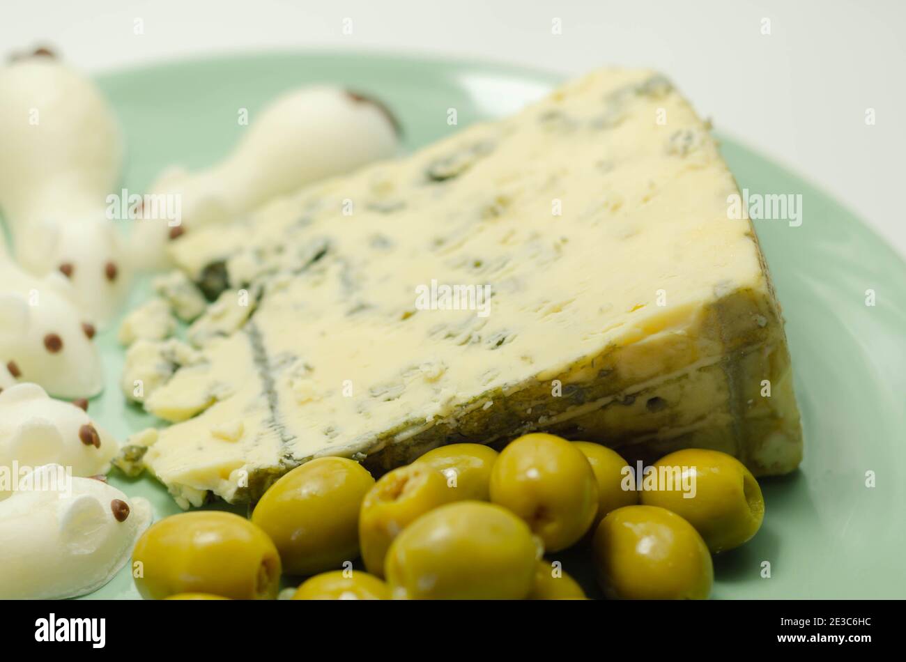 Full fat soft blue veined cheese with olives and snacks in the shape of ...