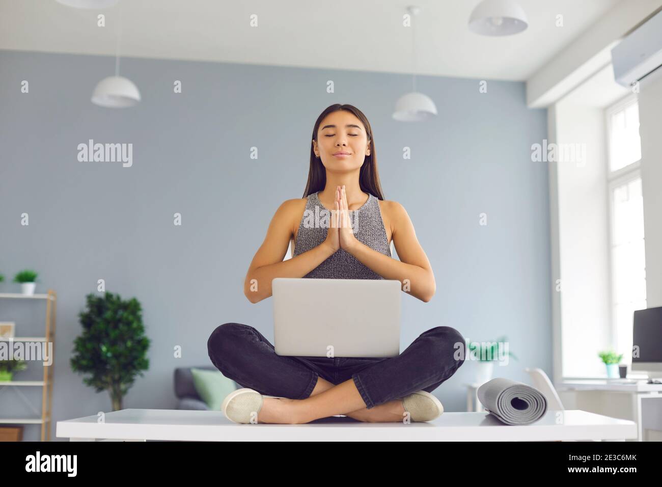Asian woman meditating in computer hi-res stock photography and images ...