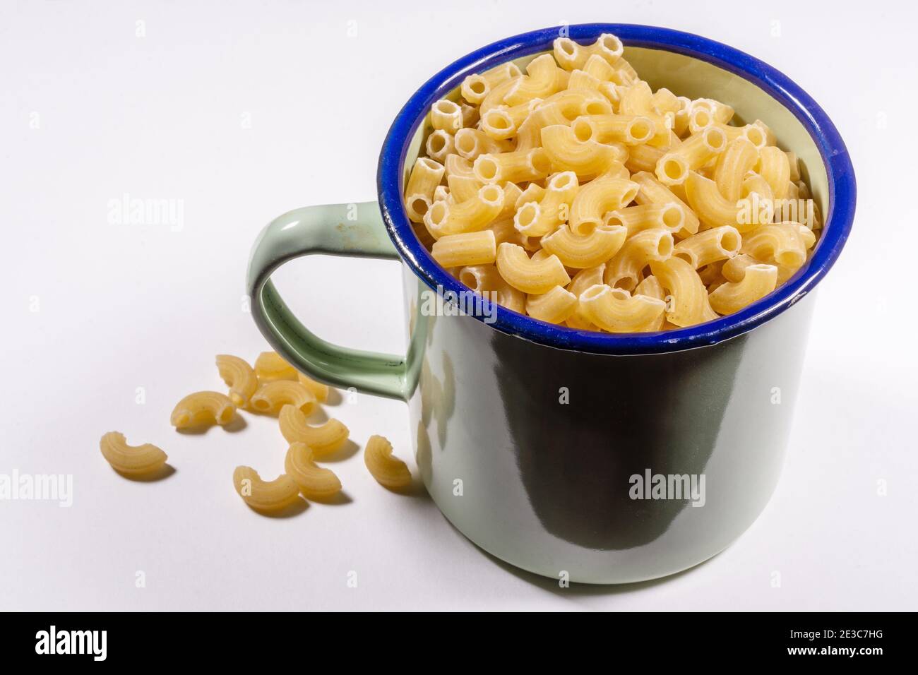 Short macaroni in an enamelled mug Stock Photo - Alamy