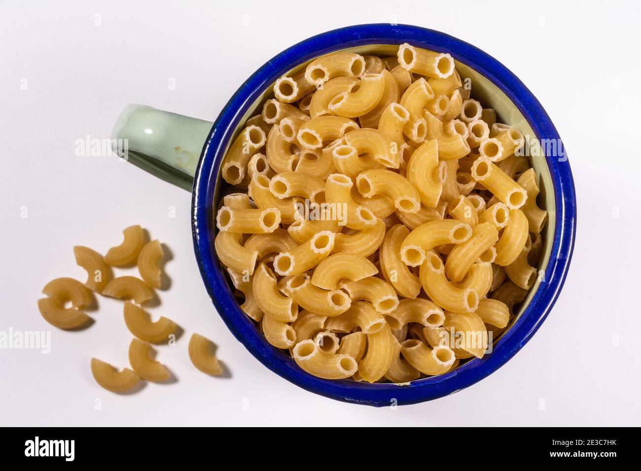 Short macaroni in an enamelled mug Stock Photo - Alamy