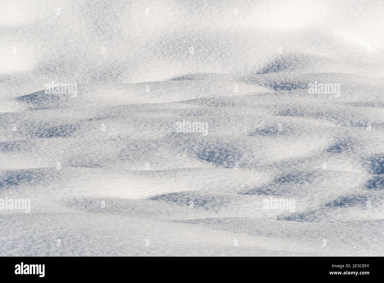 Smooth snow drifts on sunny winter day. Deep and high snow drifts ...