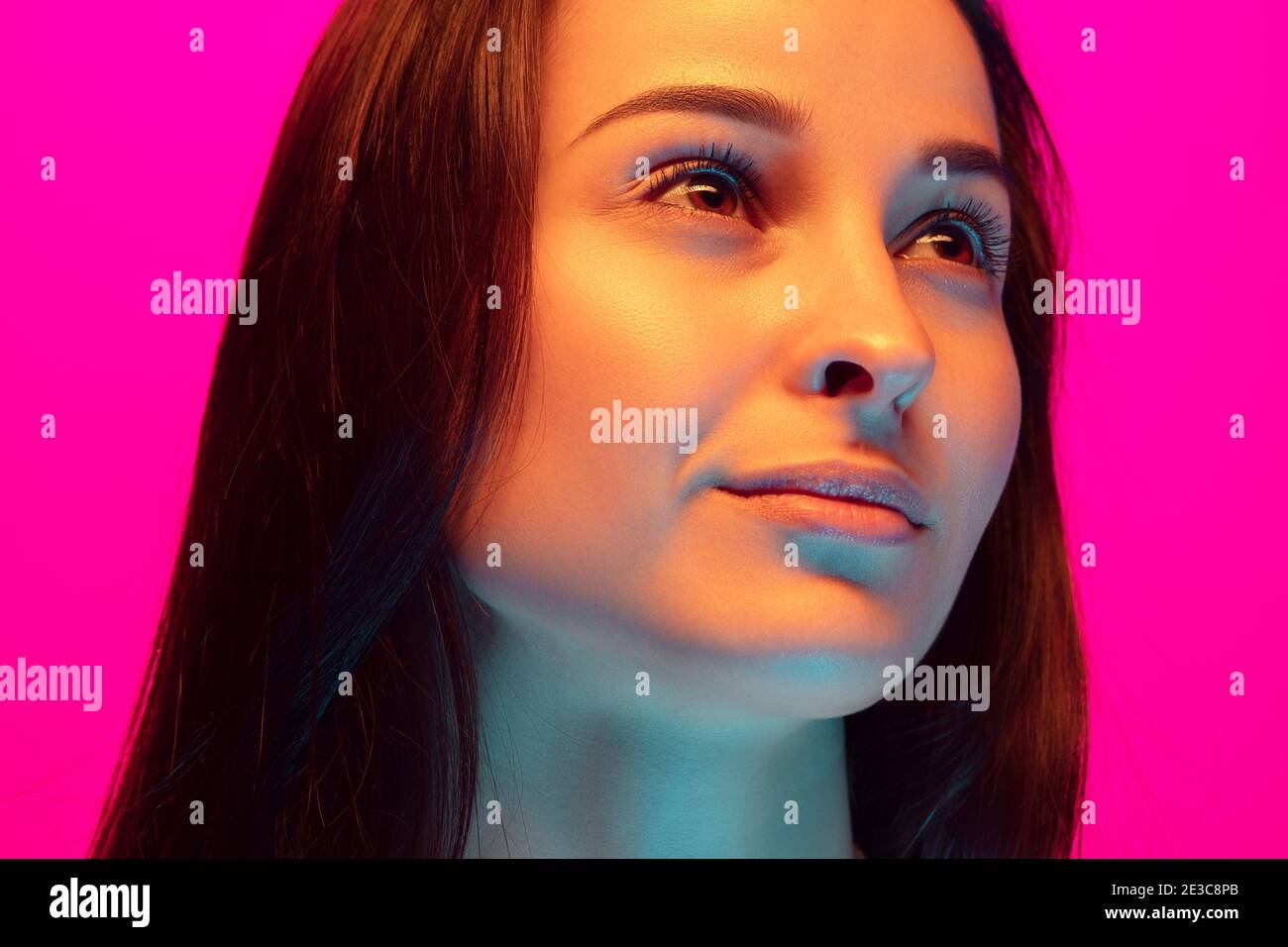 Close up caucasian woman's portrait isolated on pink studio background ...
