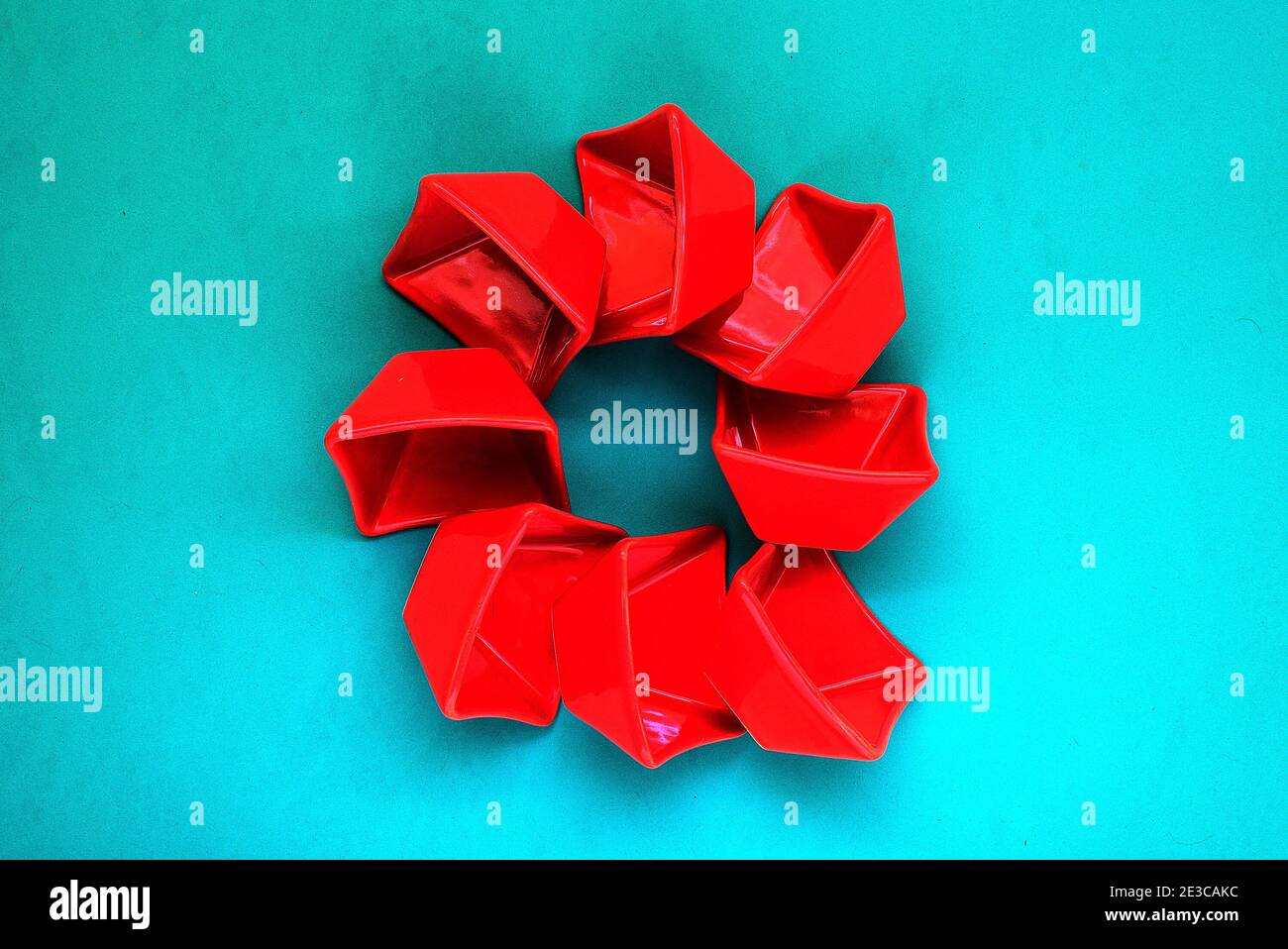 Closeup shot of red small bowls on a light blue background Stock Photo ...