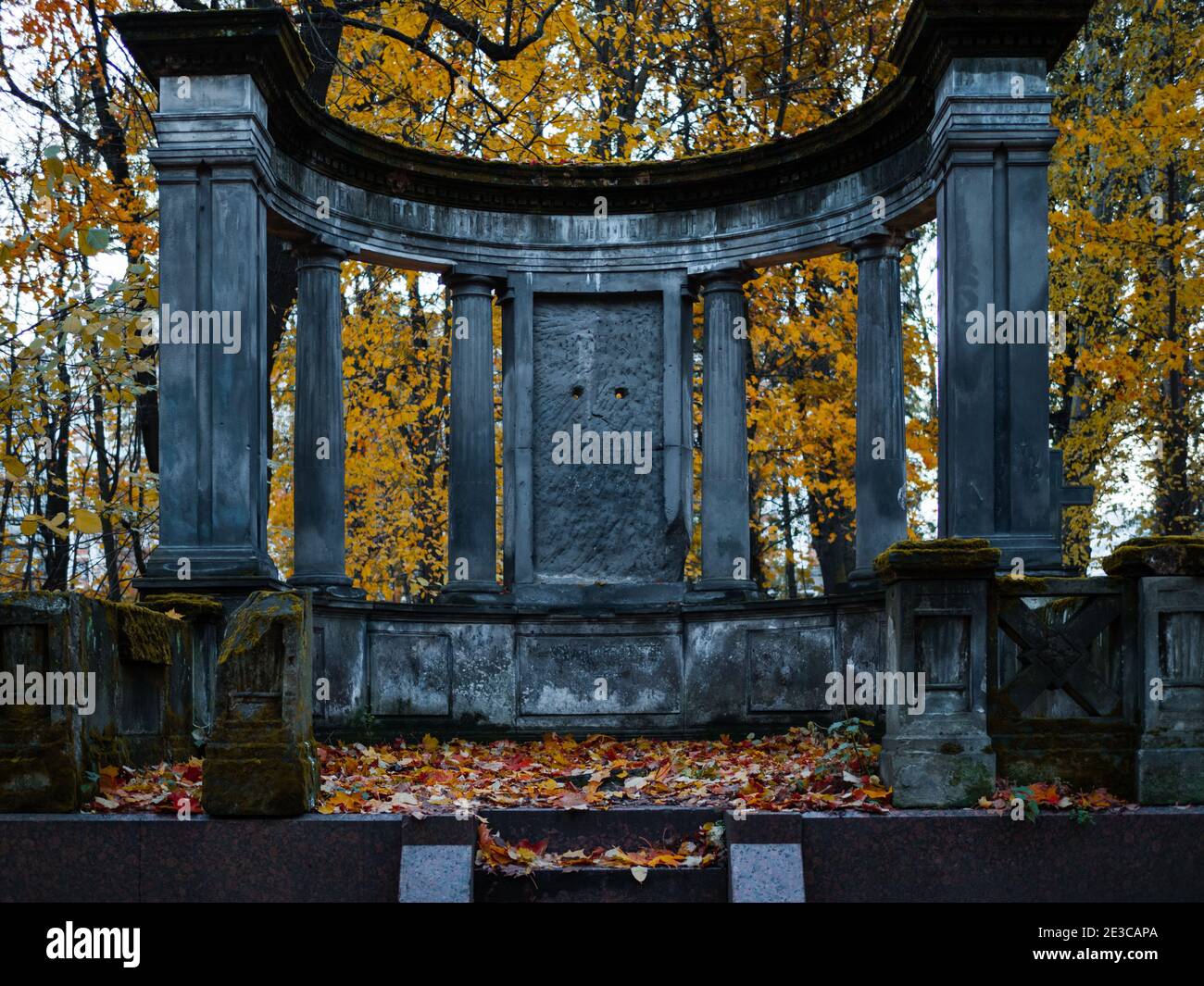 The old Catholic cemetery in the fall. Abandoned graves under a layer ...