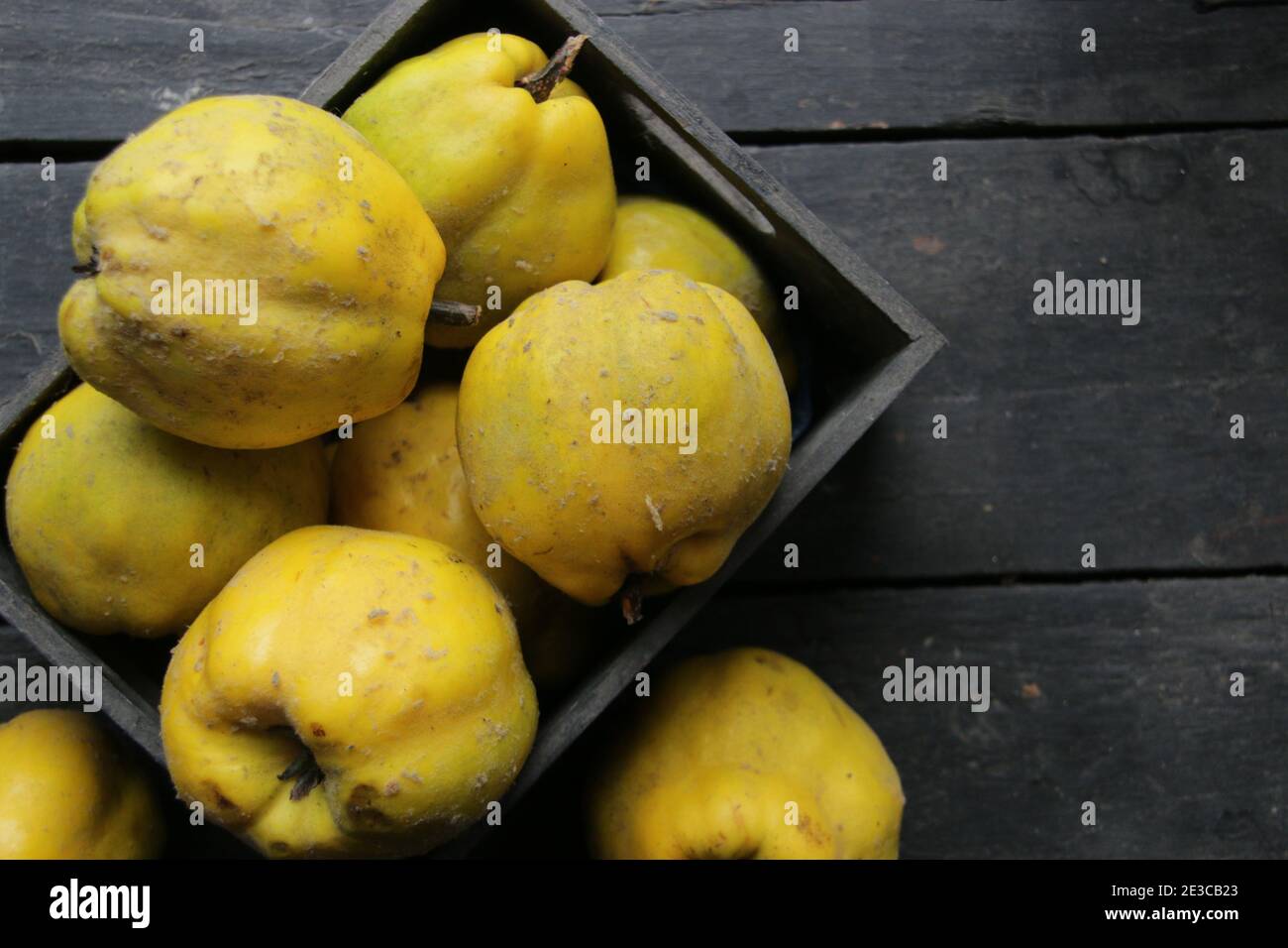 Ripe, fresh, biting quince on a vintage table. Food background Stock ...
