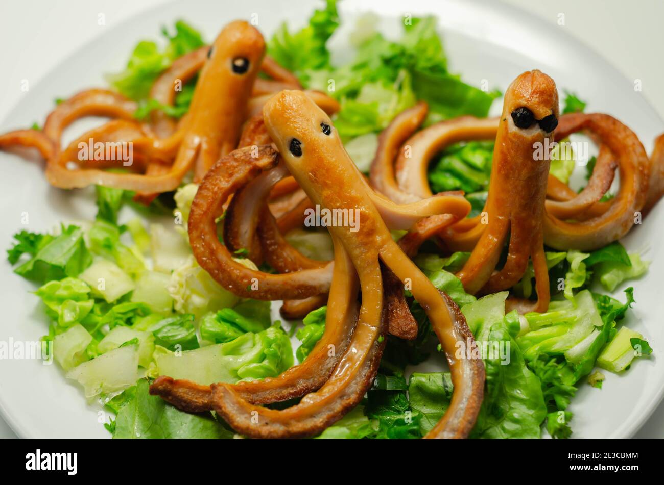 Creative meal for a child, fried sausages in an octopus shape served ...