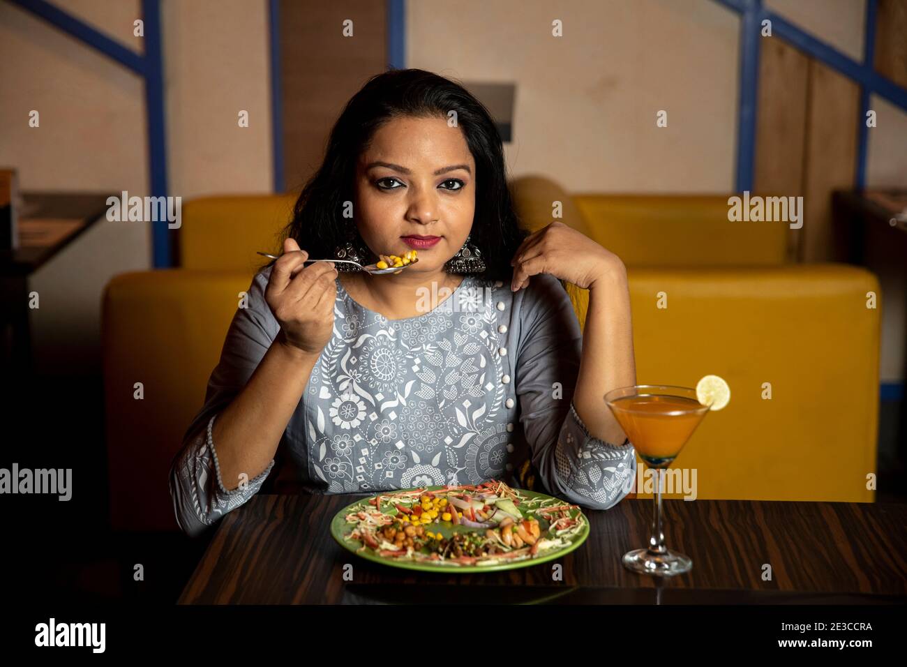 Portrait of a pretty woman eating delicious food in a restaurant Stock ...