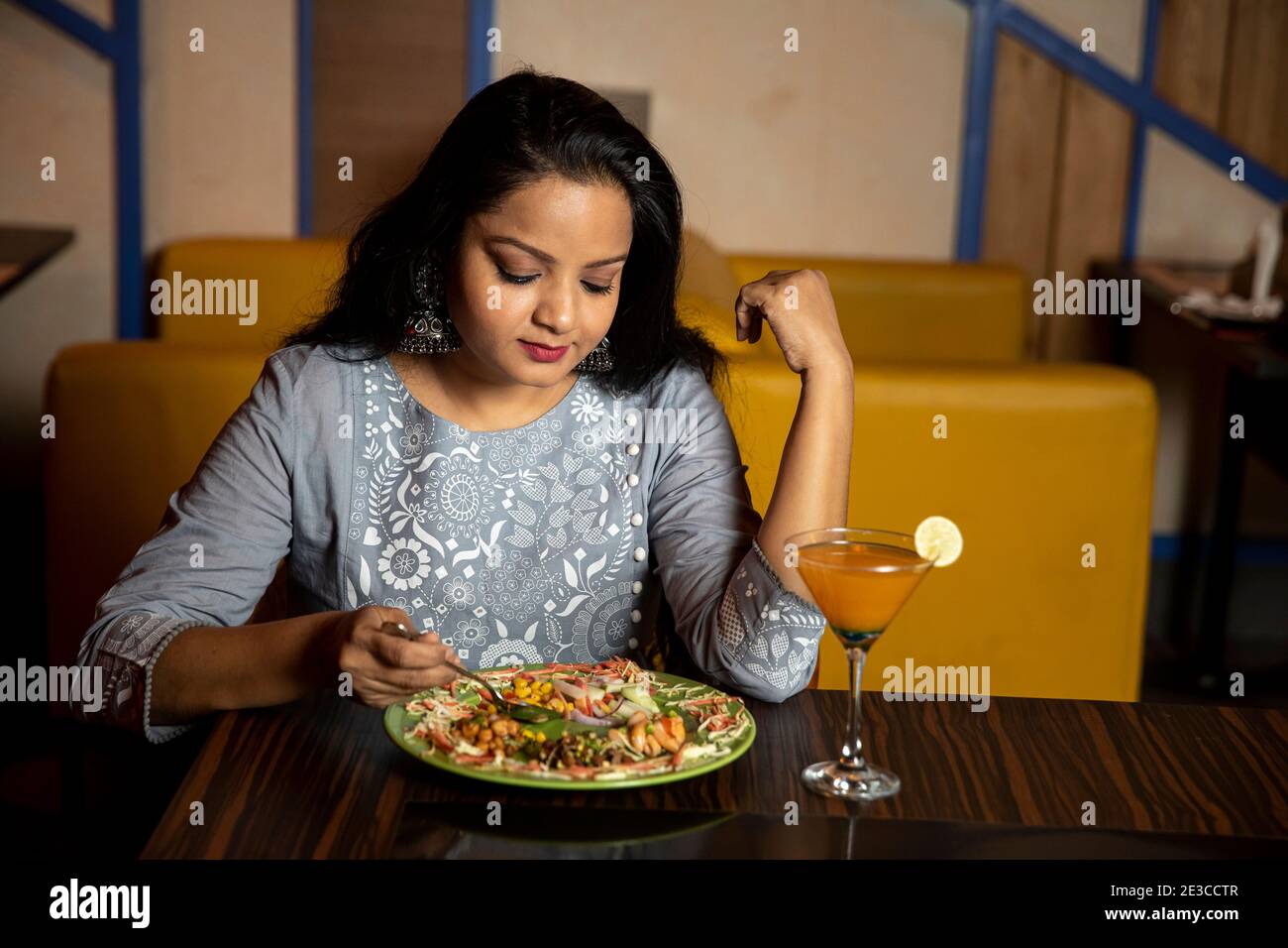 Portrait of a pretty woman eating delicious food in a restaurant Stock ...
