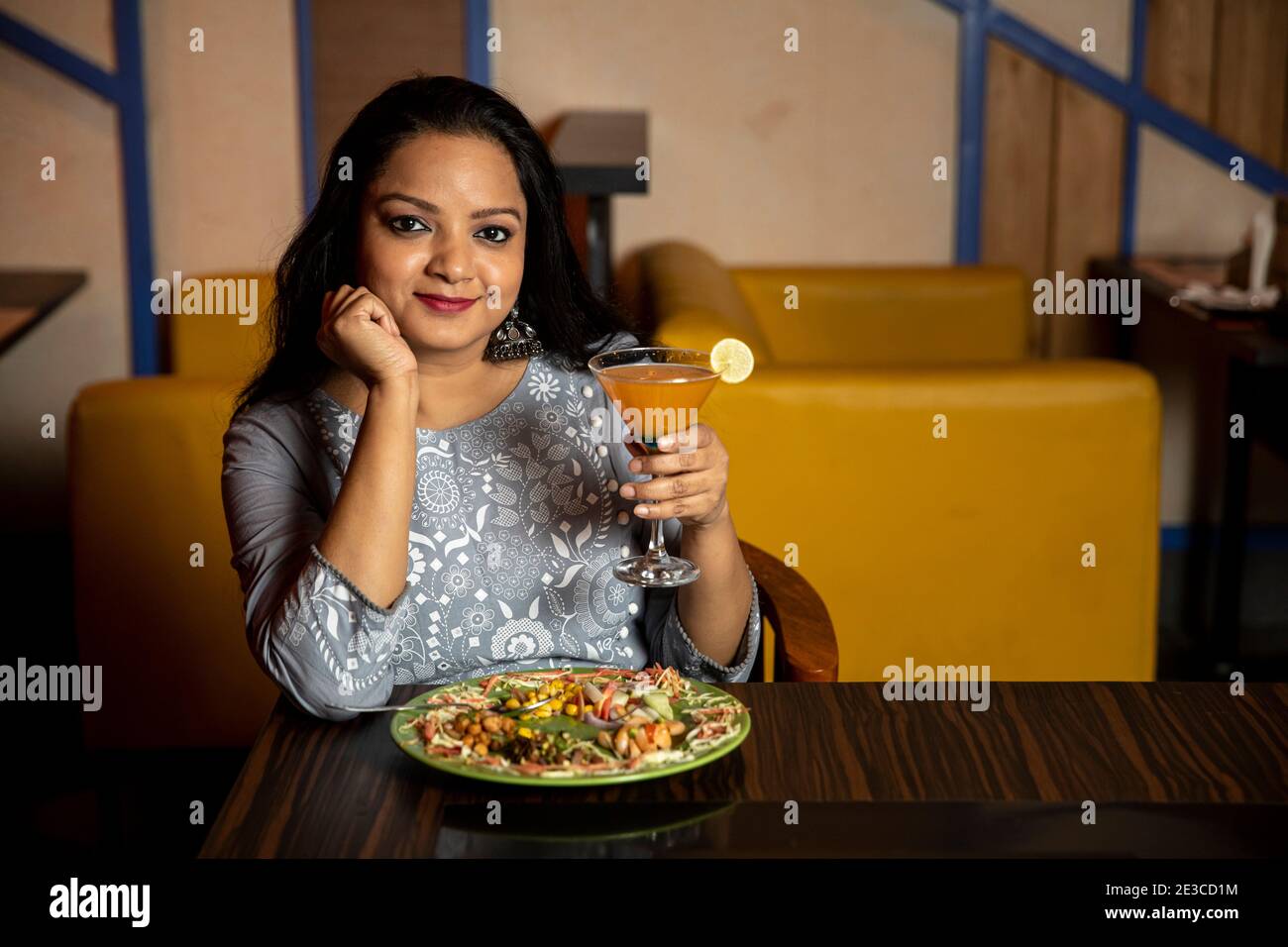 Portrait of a pretty woman eating delicious food in a restaurant Stock ...