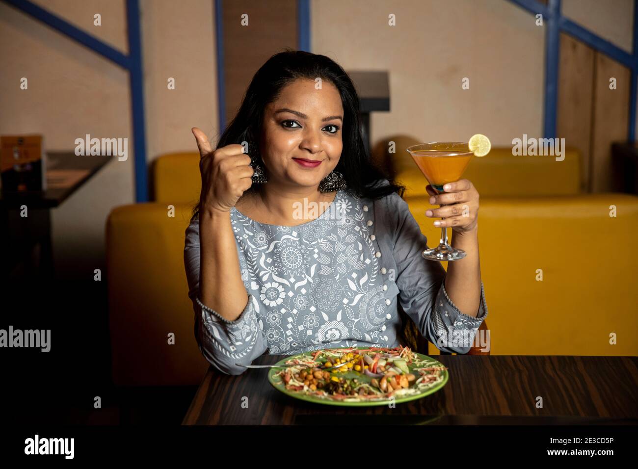 Portrait of a pretty woman eating delicious food in a restaurant Stock ...