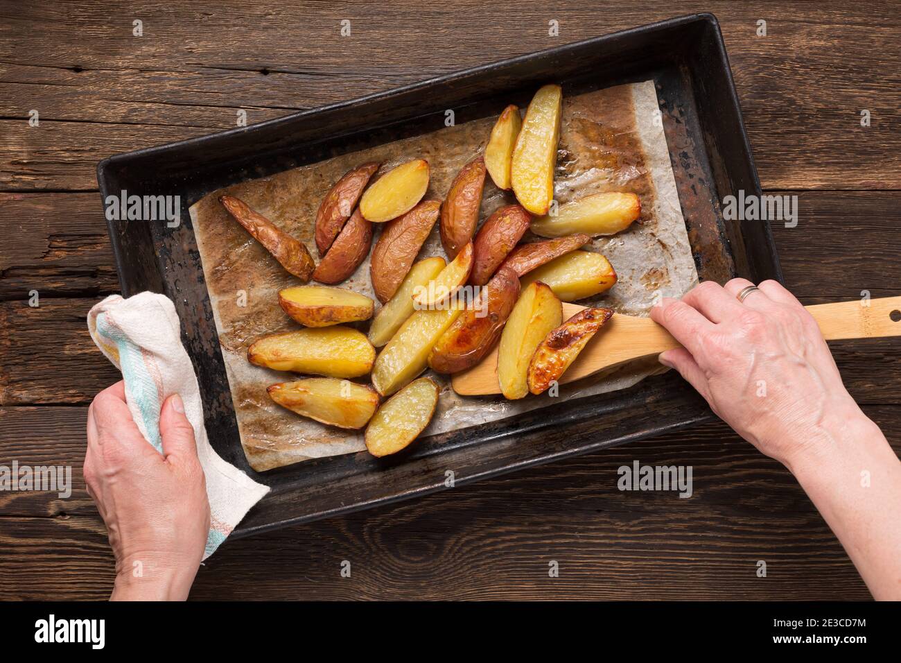 Woman serving baked potatoes for lunch Stock Photo - Alamy