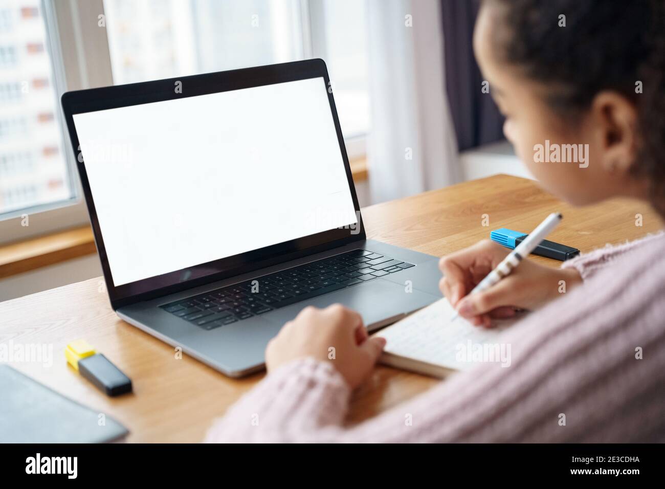 Mockup on laptop with young girl studying online on laptop Stock Photo ...