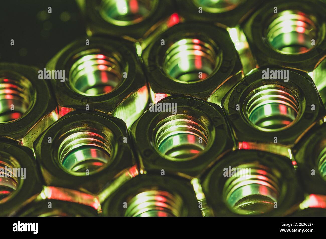 Closeup shot of screw nuts with the colorful lights coming under it ...