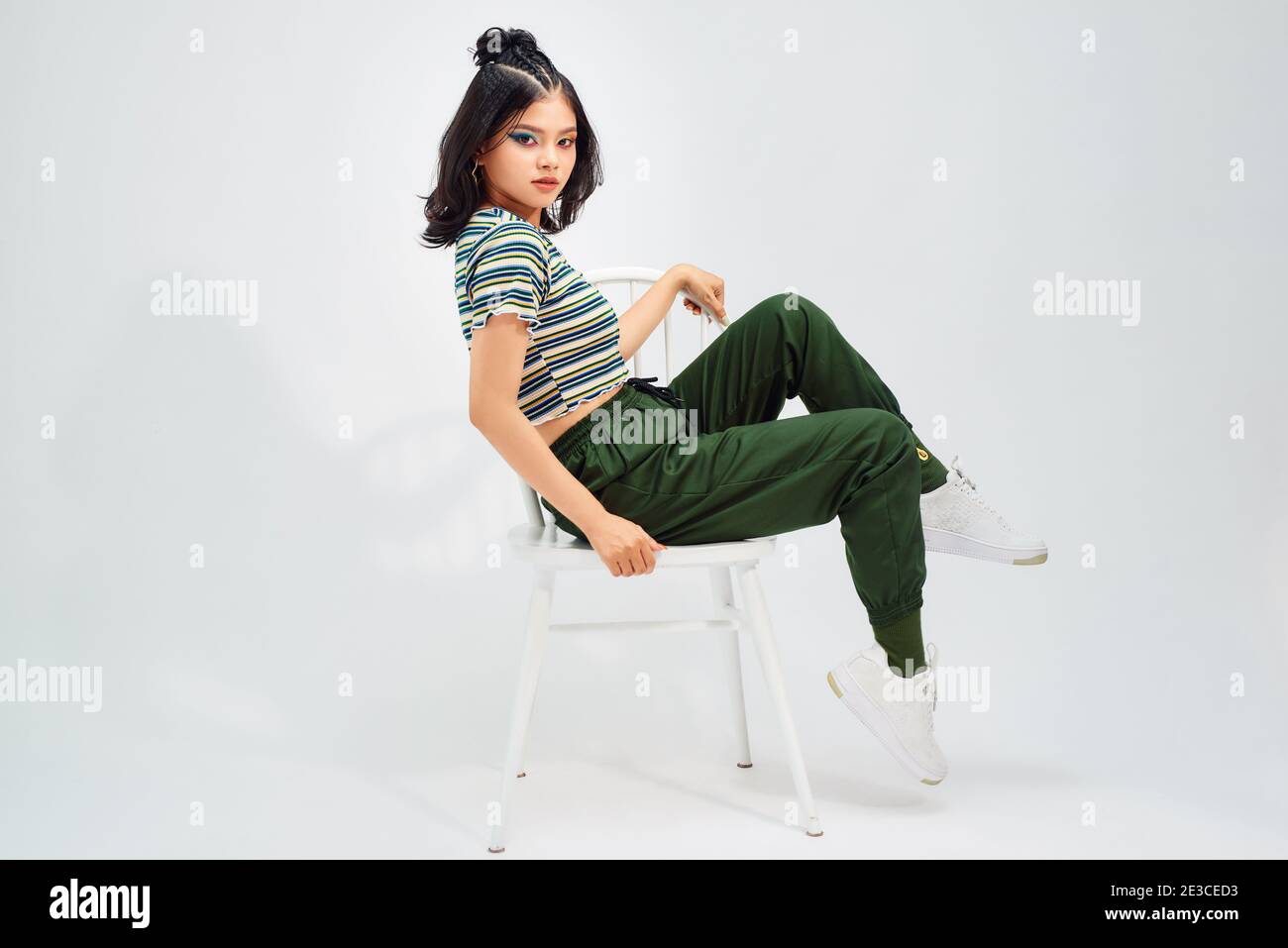 She is simply gorgeous. Beautiful young woman posing and looking away ...