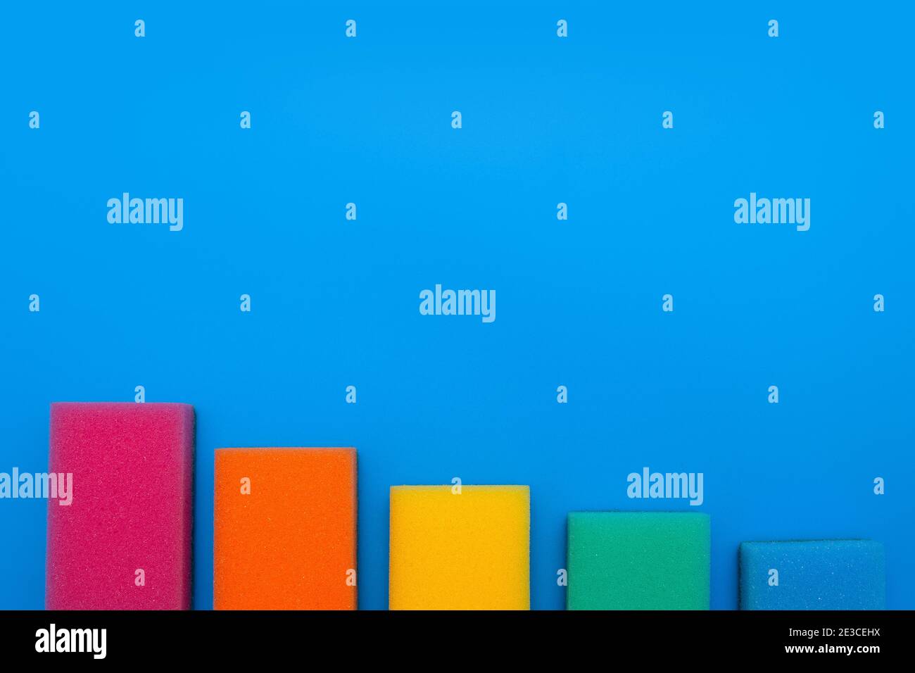 colorful, five rainbow colored sponges on blue background Stock Photo ...