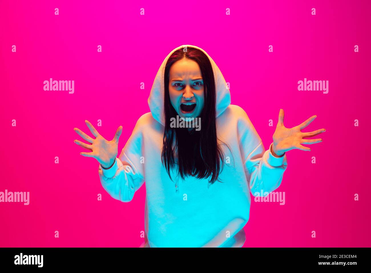 Angry scream. Caucasian woman's portrait isolated on pink studio ...