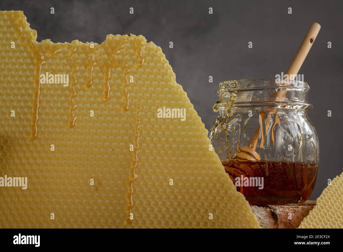 Jar with raw honey and bee comb on dark background, healthy nutrition ...