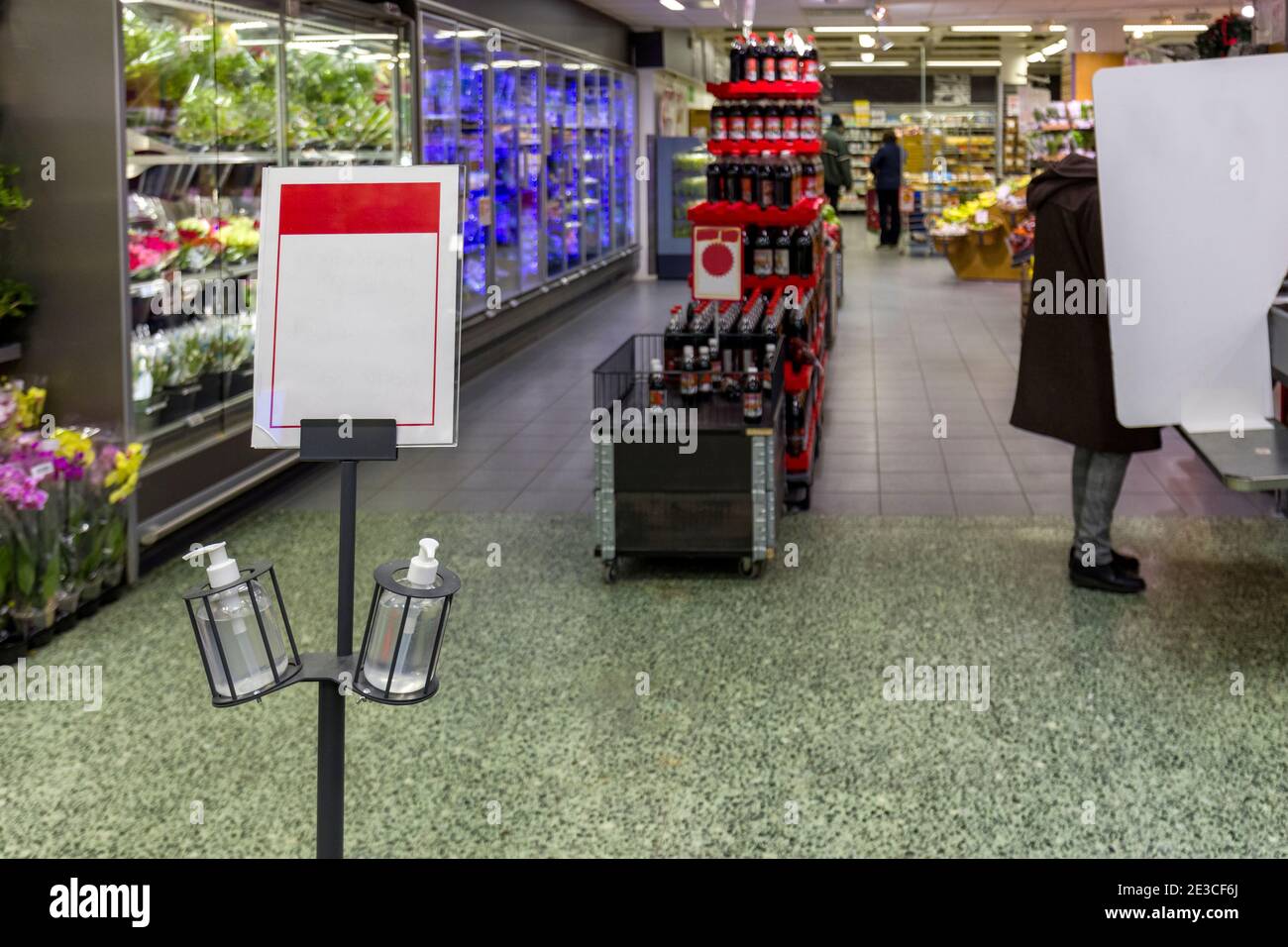 Supermarket combating Covid-19 by having stand with hand sanitizers and ...