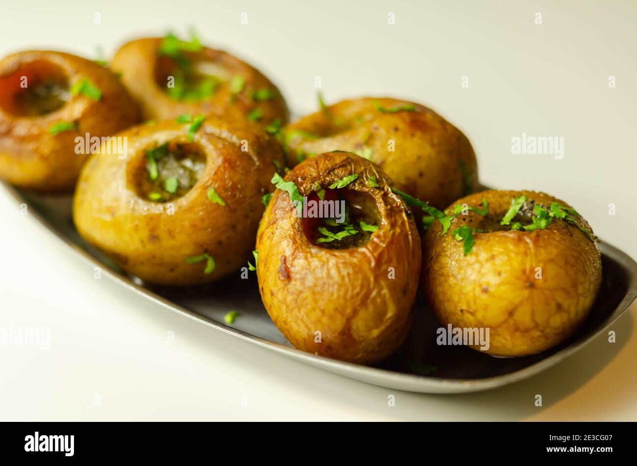 Mini jacket potatoes with a fragrant garlic butter infused with Italian ...
