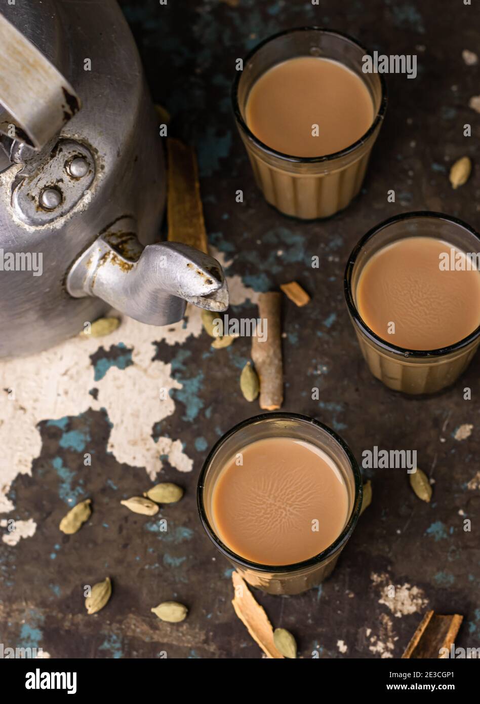 Indian chai in glass cups with metal kettle and other masalas to make ...