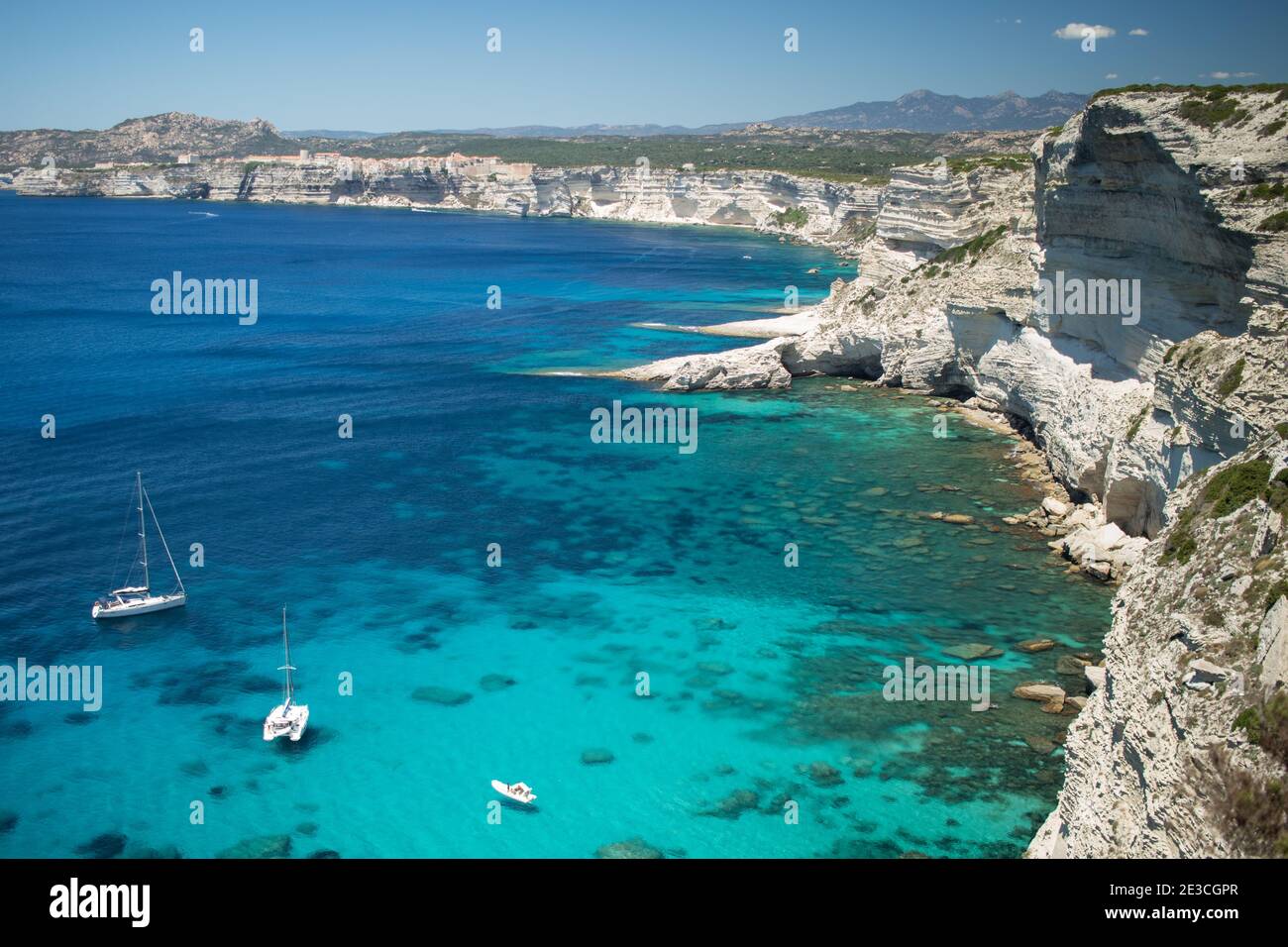 Beautiful turquoise sea lagoon with small boats near huge cliff ...