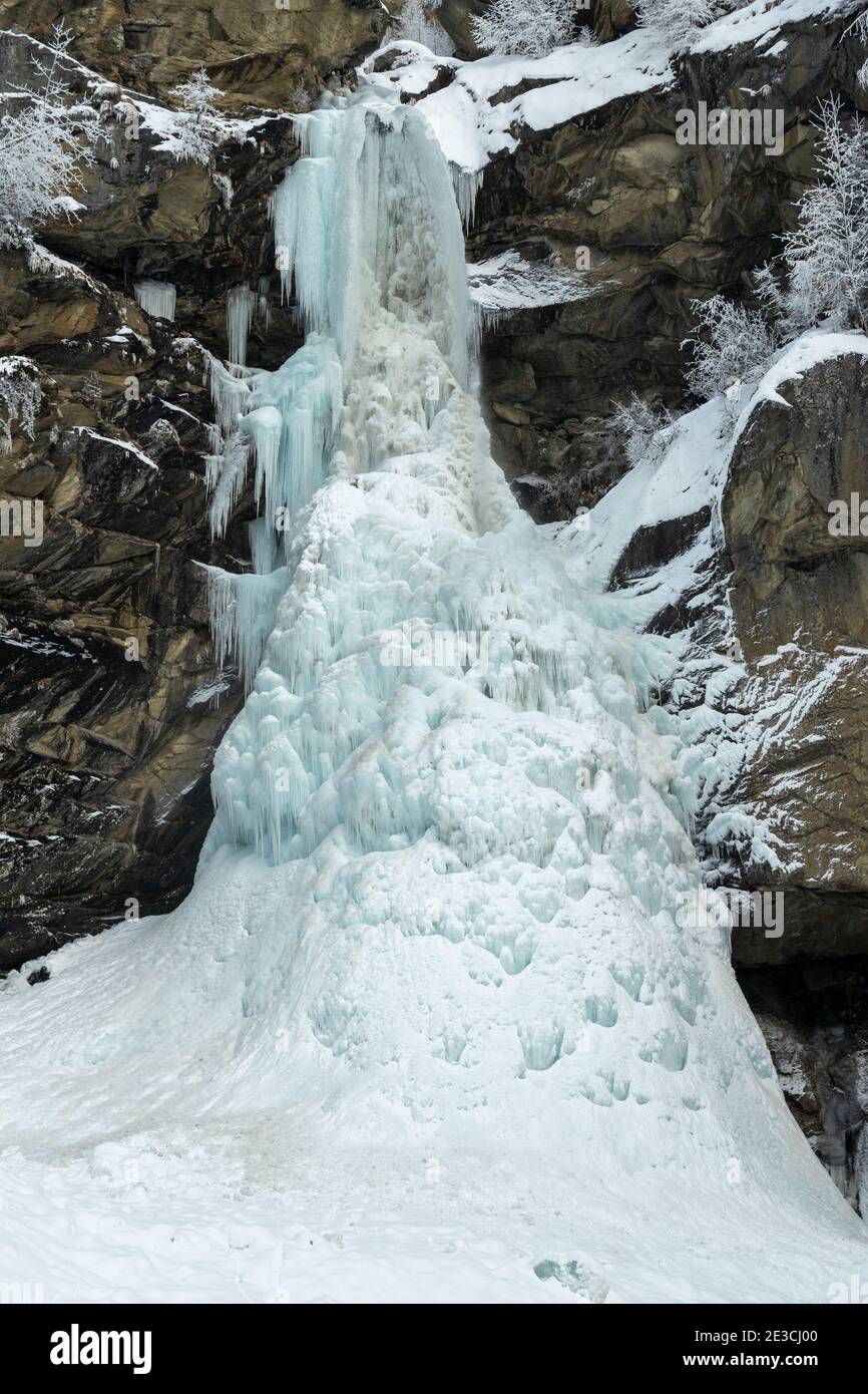 A photograph of a frozen waterfall in Saas-Balen in winter. Saas-Balen ...