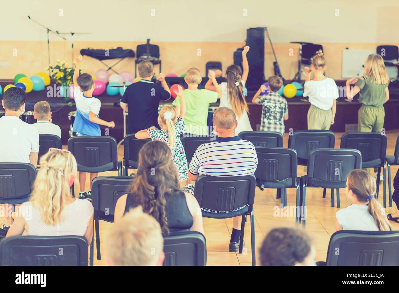 Children's holiday in elementary School. Children on stage perform in ...