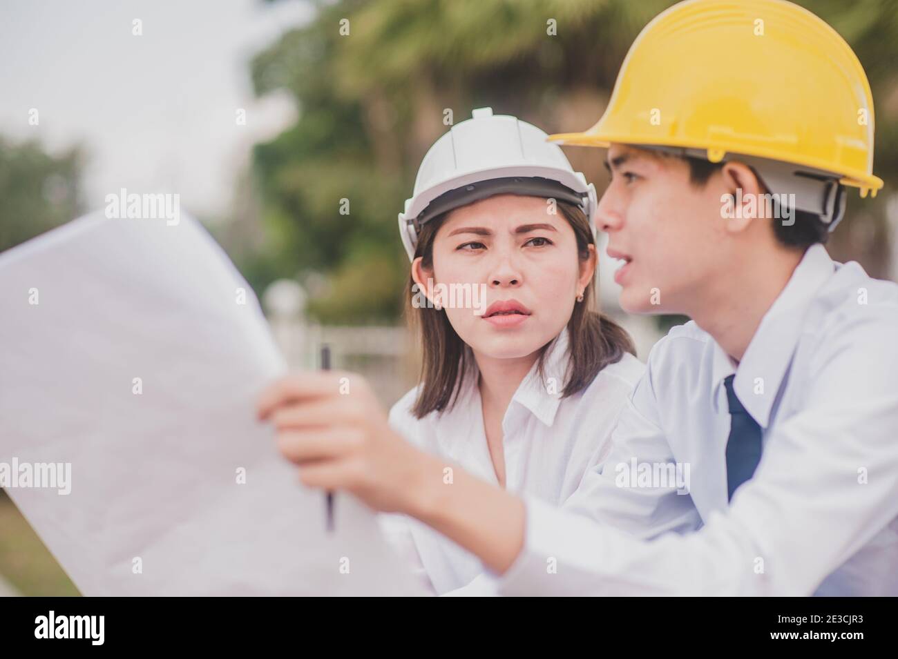 Two people engineer use blueprint talking discussion building civil ...