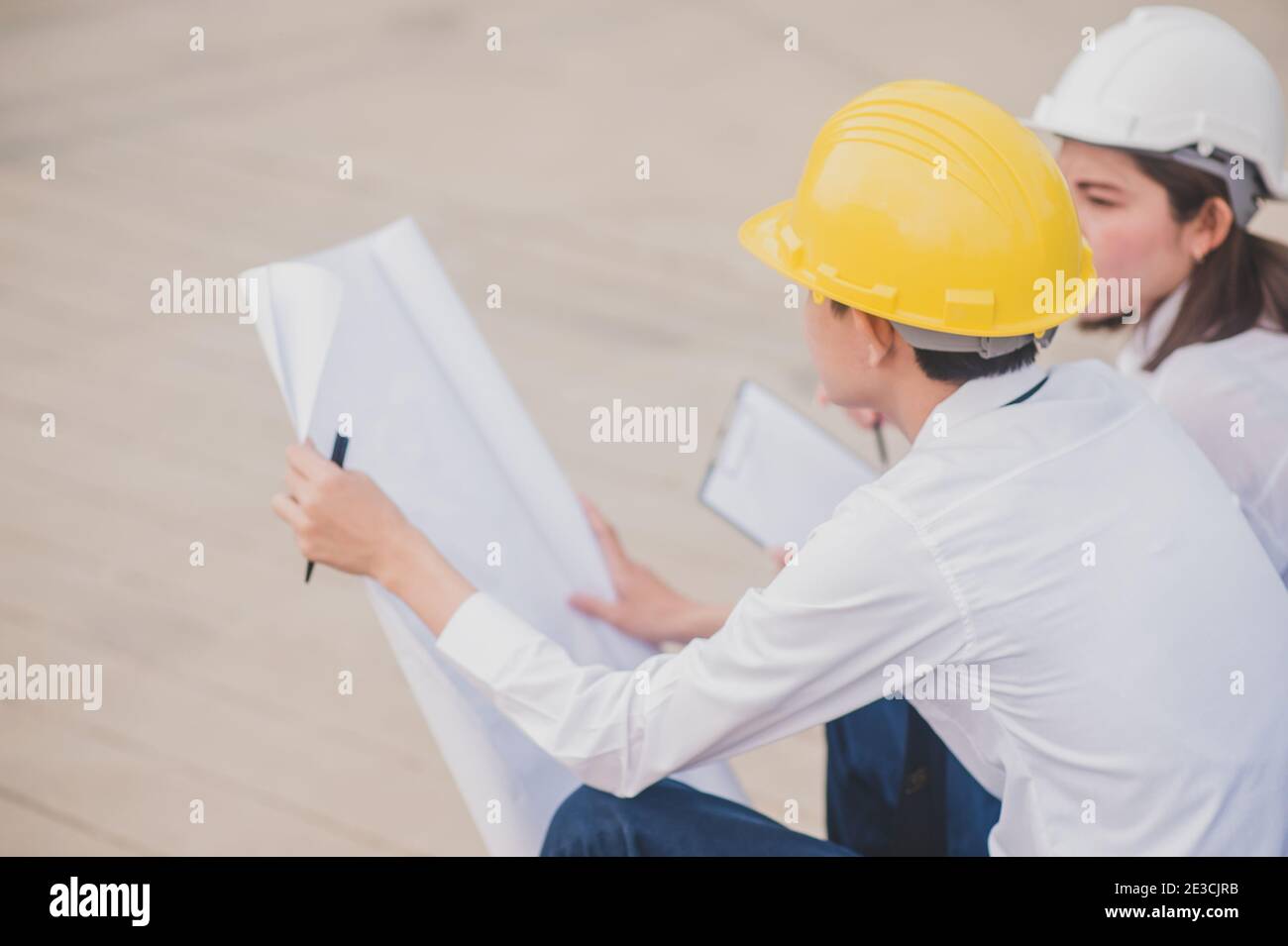 Two people engineer use blueprint talking discussion building civil ...