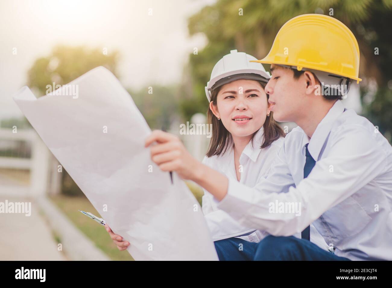 Two people engineer use blueprint talking discussion building civil ...