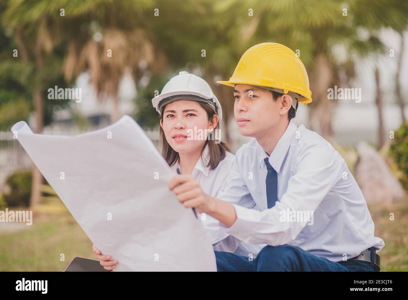 Two people engineer use blueprint talking discussion building civil ...