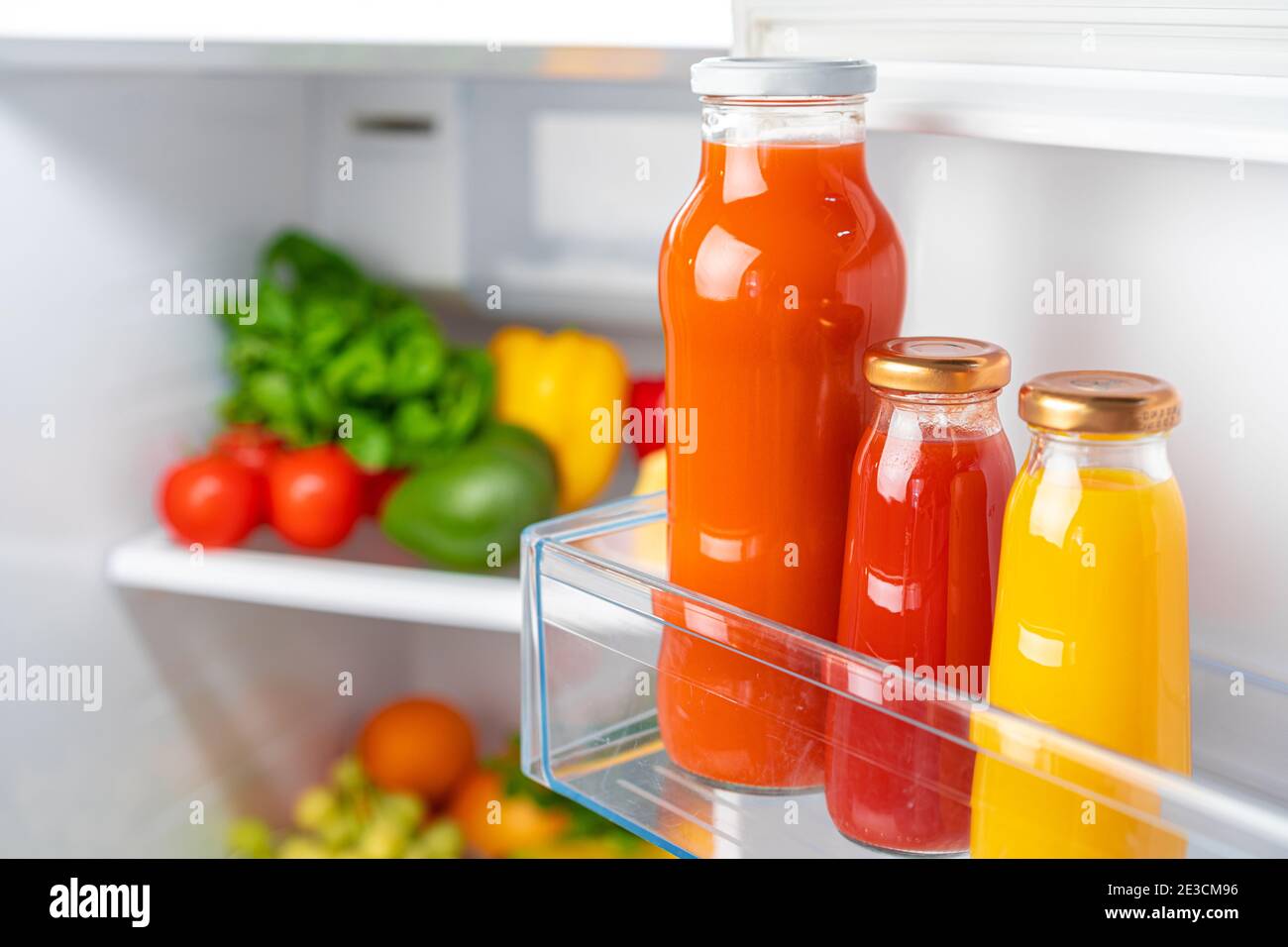 Glass bottle of juice on a fridge shelf Stock Photo - Alamy