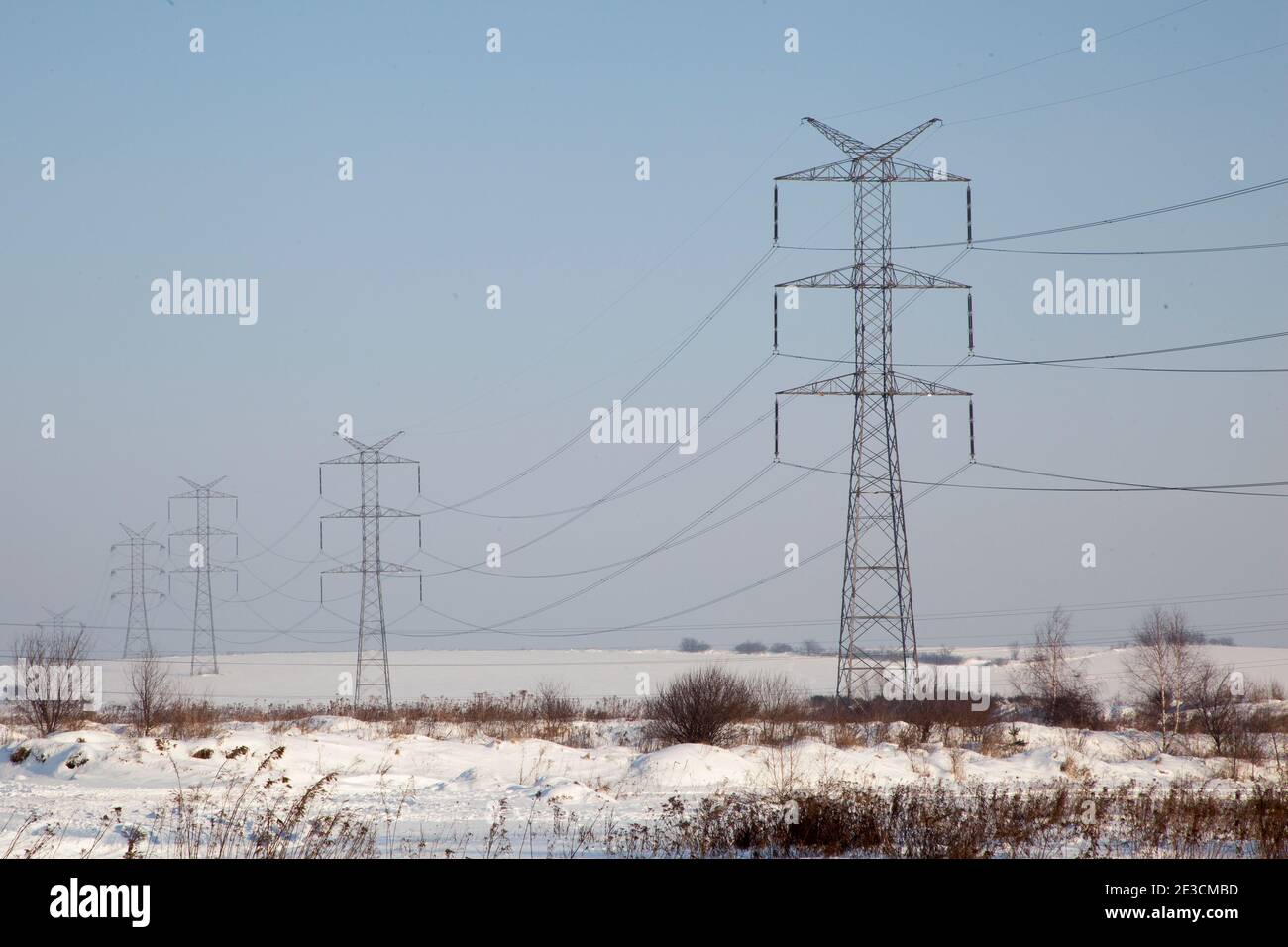 Electric Pylons in a snowy landscape Stock Photo - Alamy