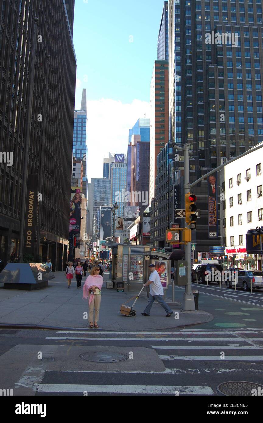 People walking man pushing a case New York USA Stock Photo - Alamy