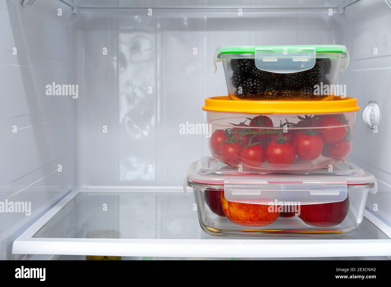 Storage containers with fresh food in a fridge Stock Photo - Alamy