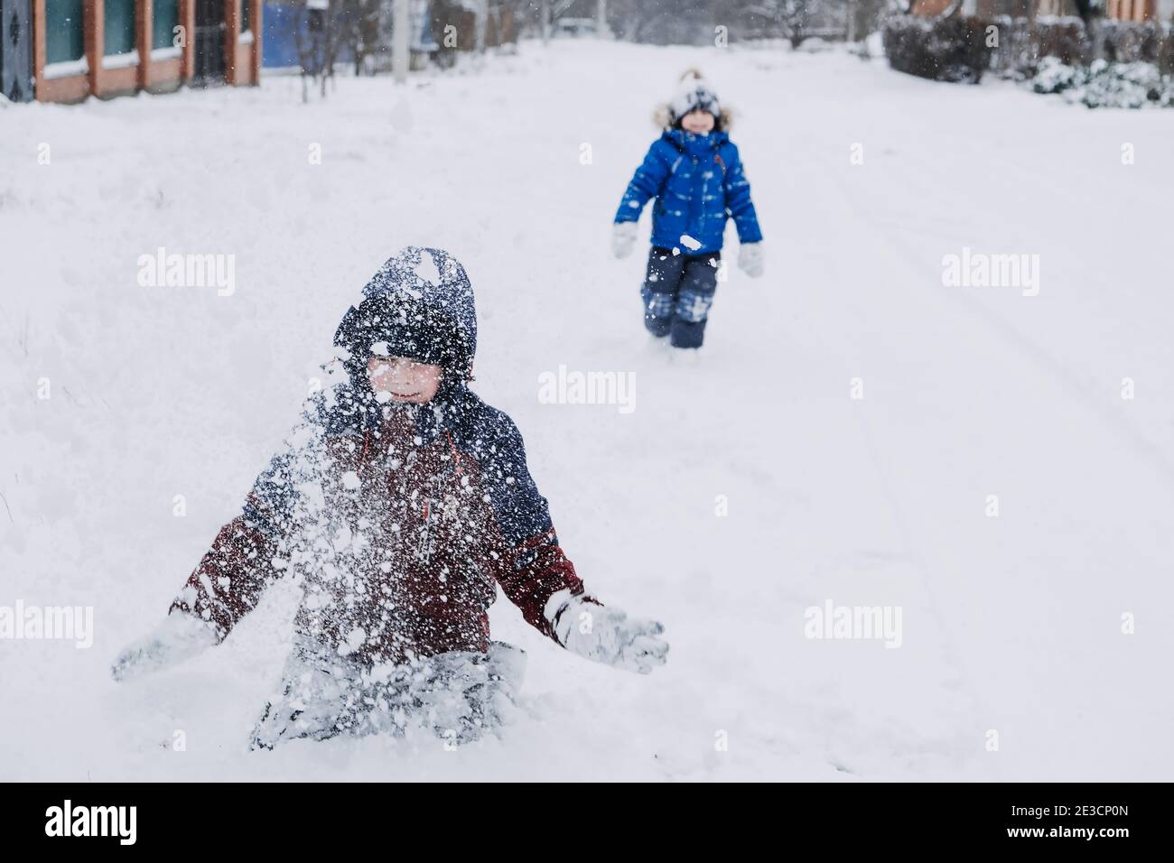 Outdoor winter activities for kids. Kids playing in the suburbs, winter ...