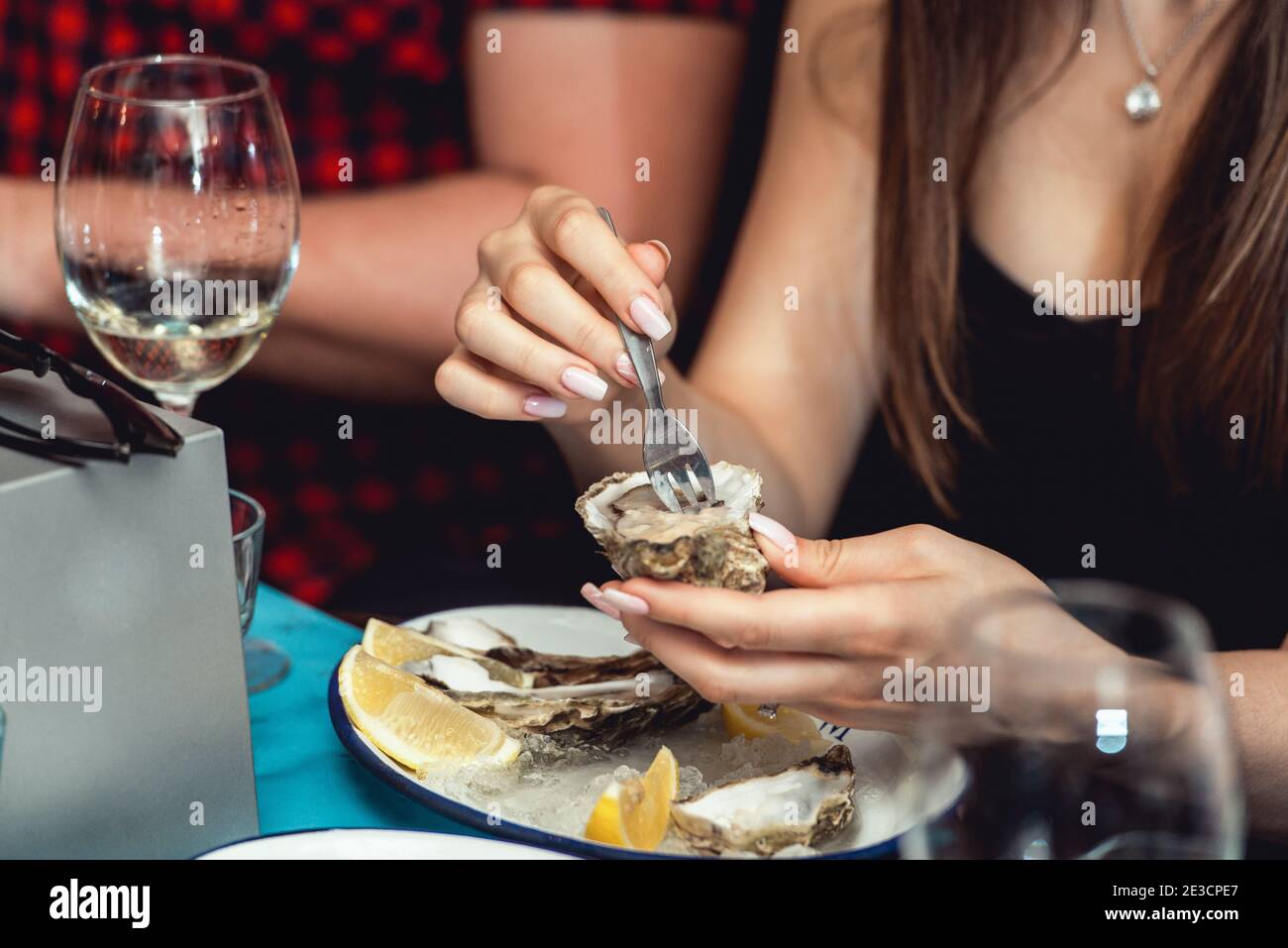 Girl eating oysters hi-res stock photography and images - Alamy