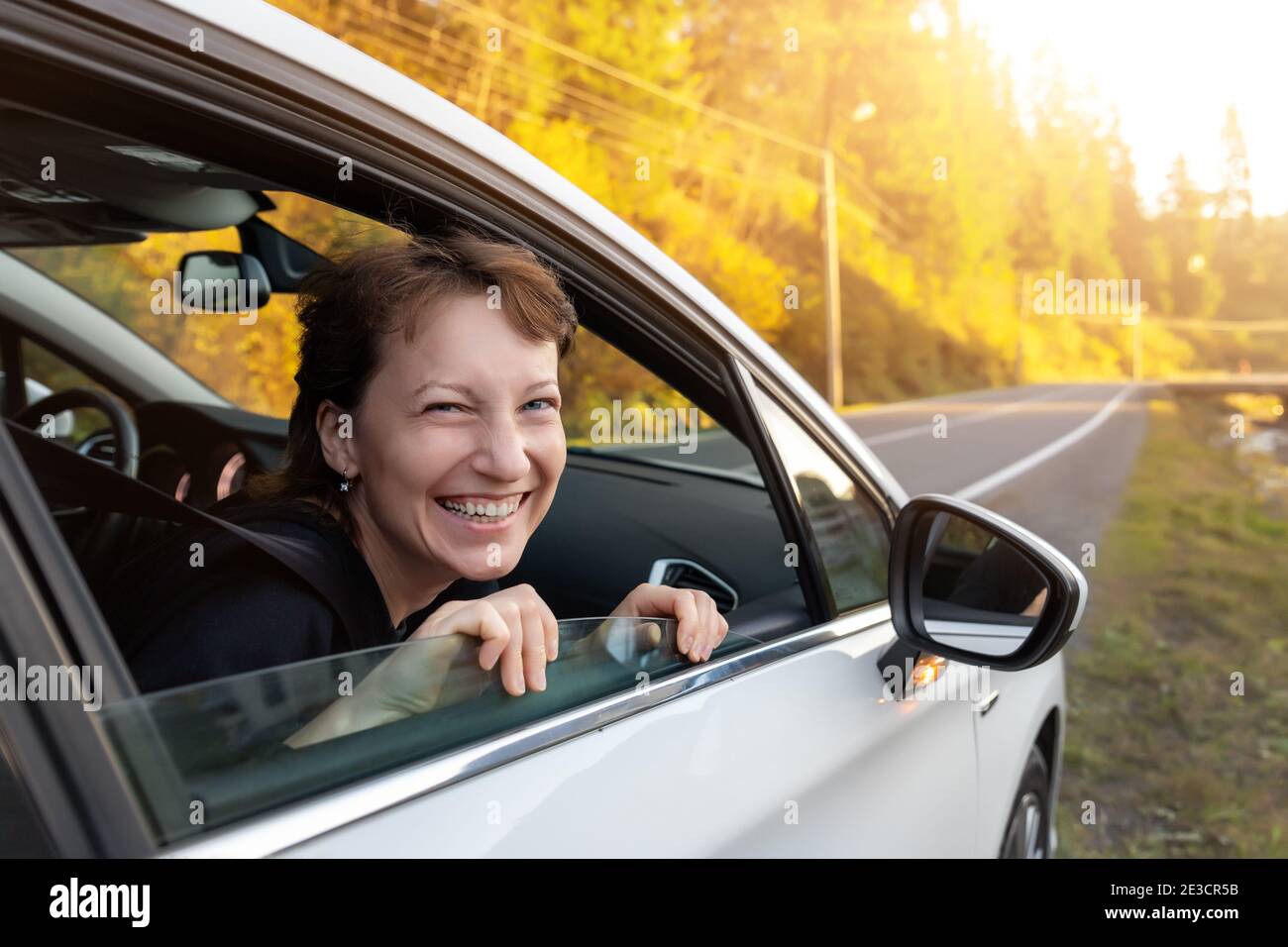 Portrait of young adult beautiful caucasian woman driver enjoy roadtrip ...