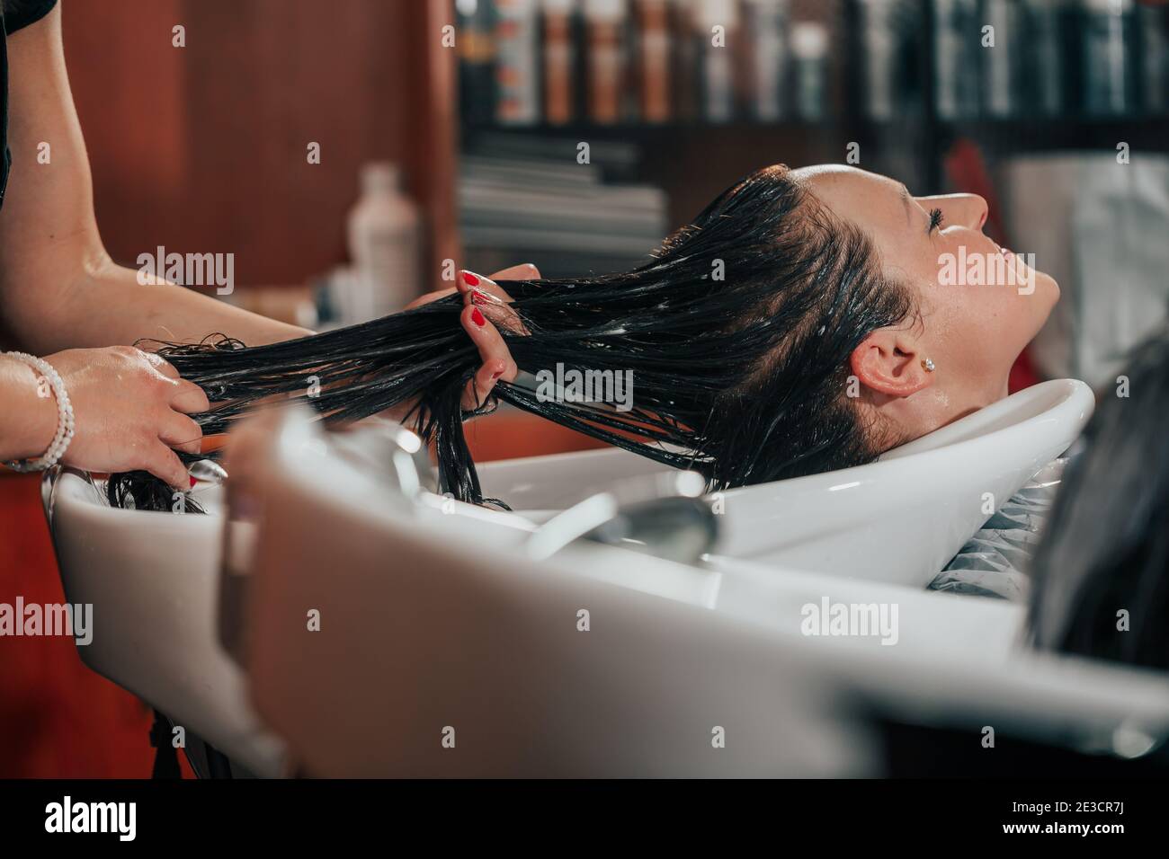 Process of hair massage in a hair studio or salon, hairstyler or ...