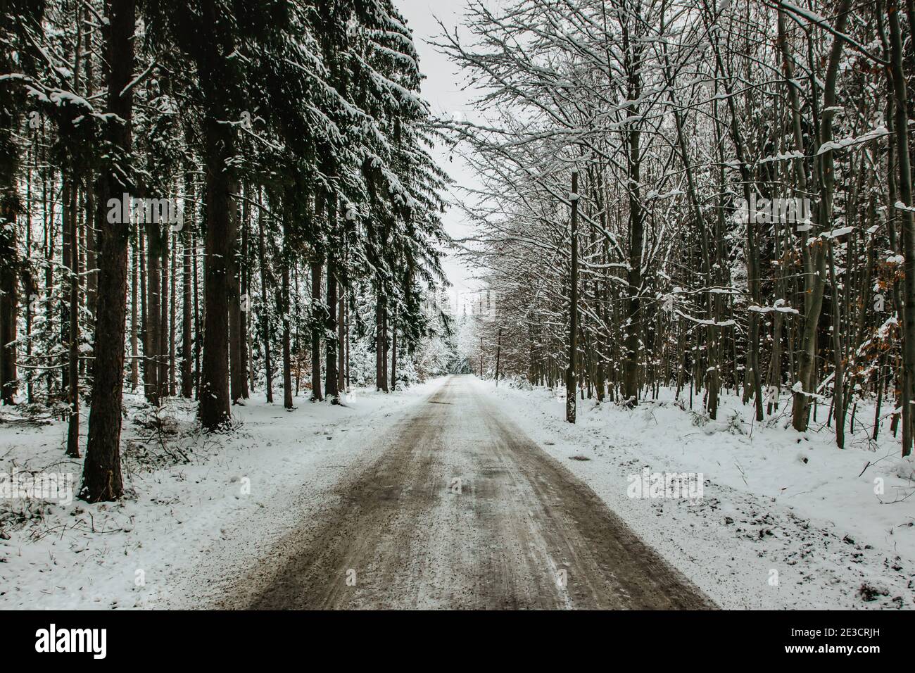 Dangerous stretch of road covered with snow and ice.Snowy road through ...