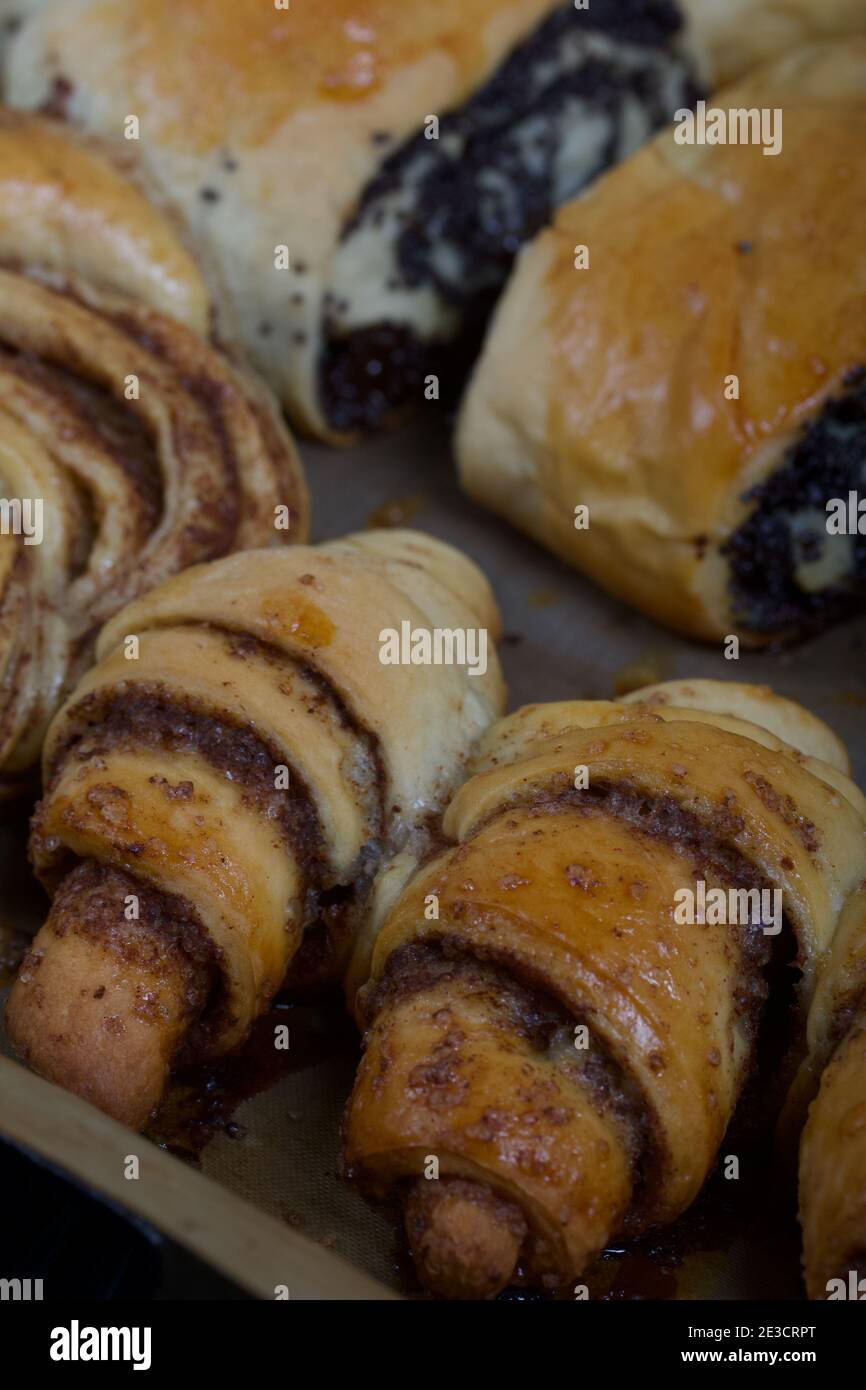 Rich pastries. The buns are on a baking sheet. Filling with poppy seeds ...