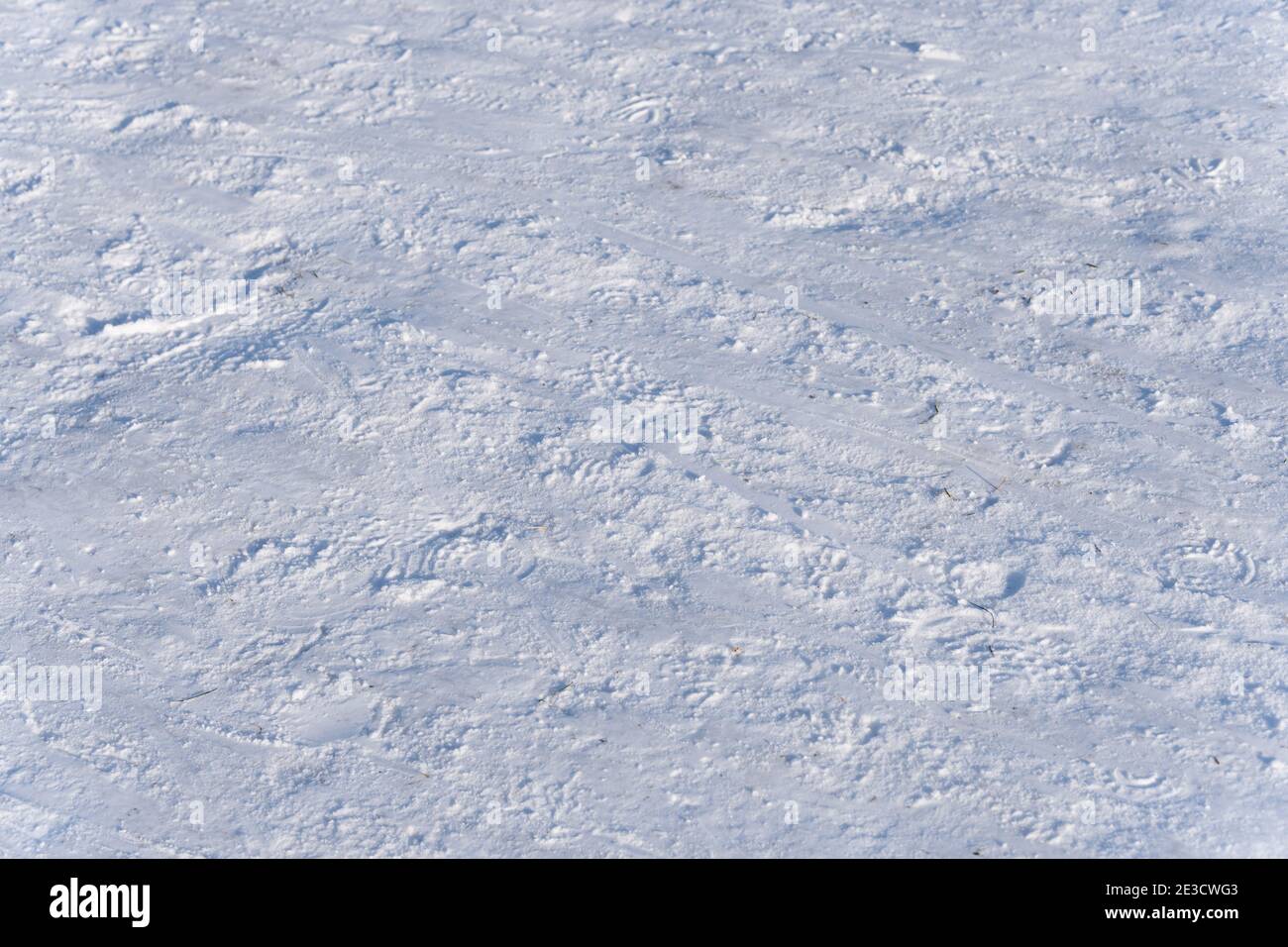 Top view closeup of the footprints of a shoe in the compacted snow on a ...
