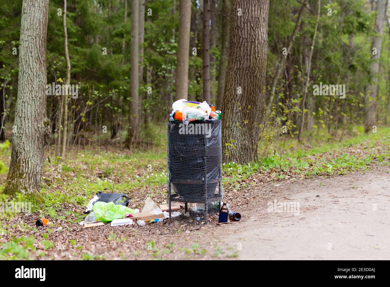 Garbage waste in park full of all sort of trash. Spring summer time ...
