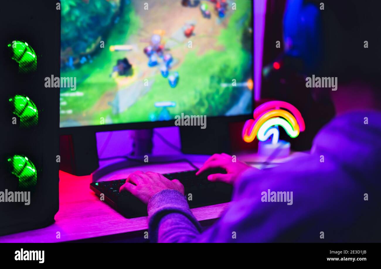 Young gamer playing online video games while streaming on social media ...