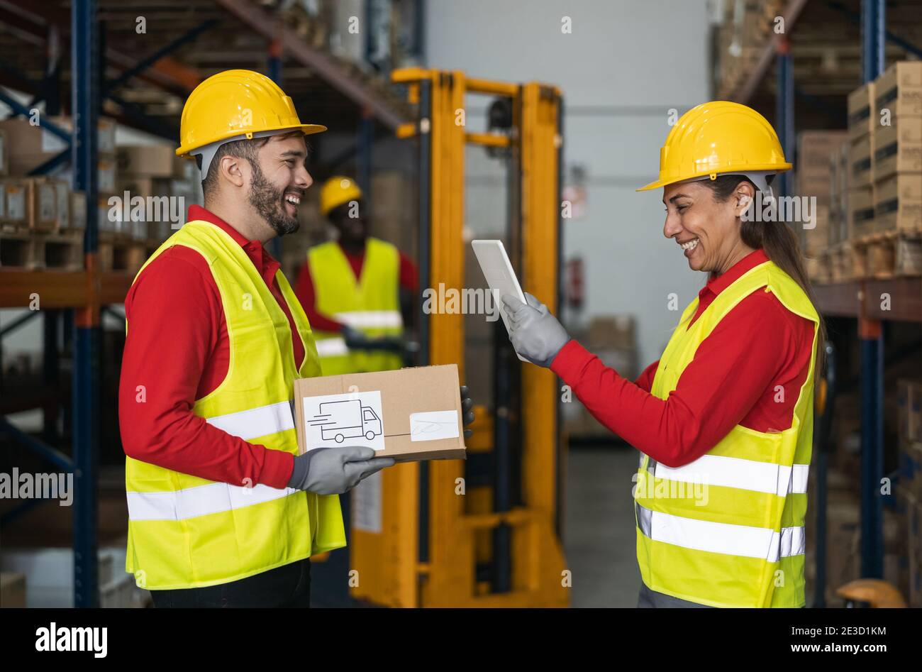 Team working in warehouse doing inventory using digital tablet and ...