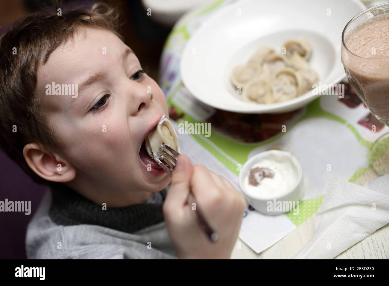 Boy eating meat dumplings in a cafe Stock Photo - Alamy
