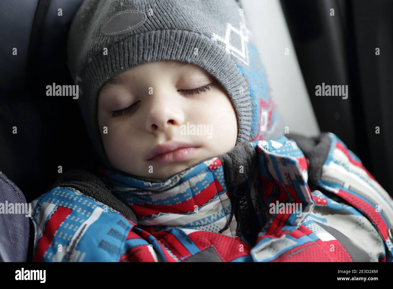 A tired boy sleeping in the car Stock Photo - Alamy