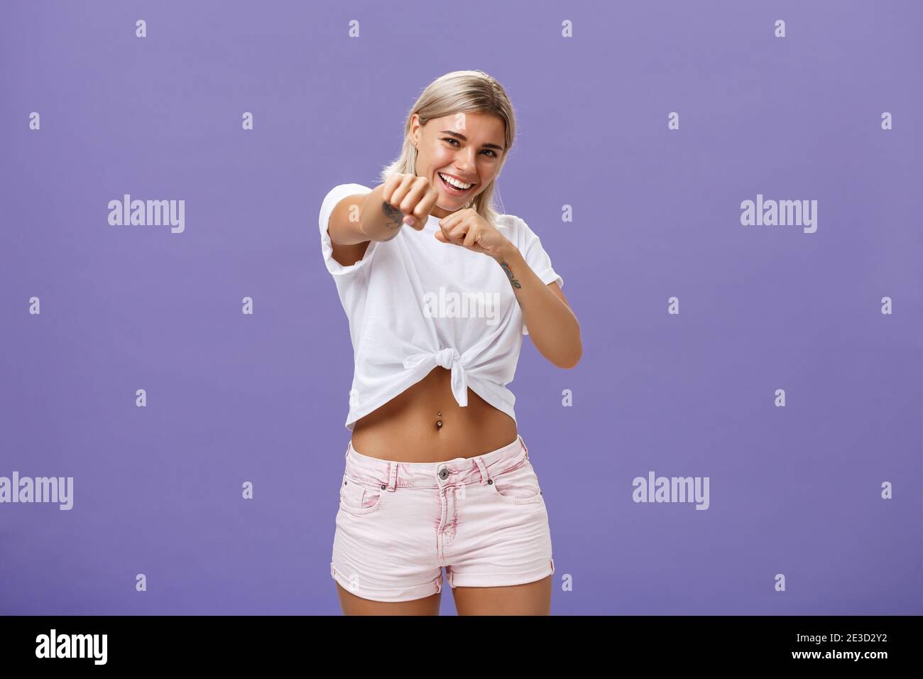 Ready fight back. Energized happy and awesome blonde female with tanned ...